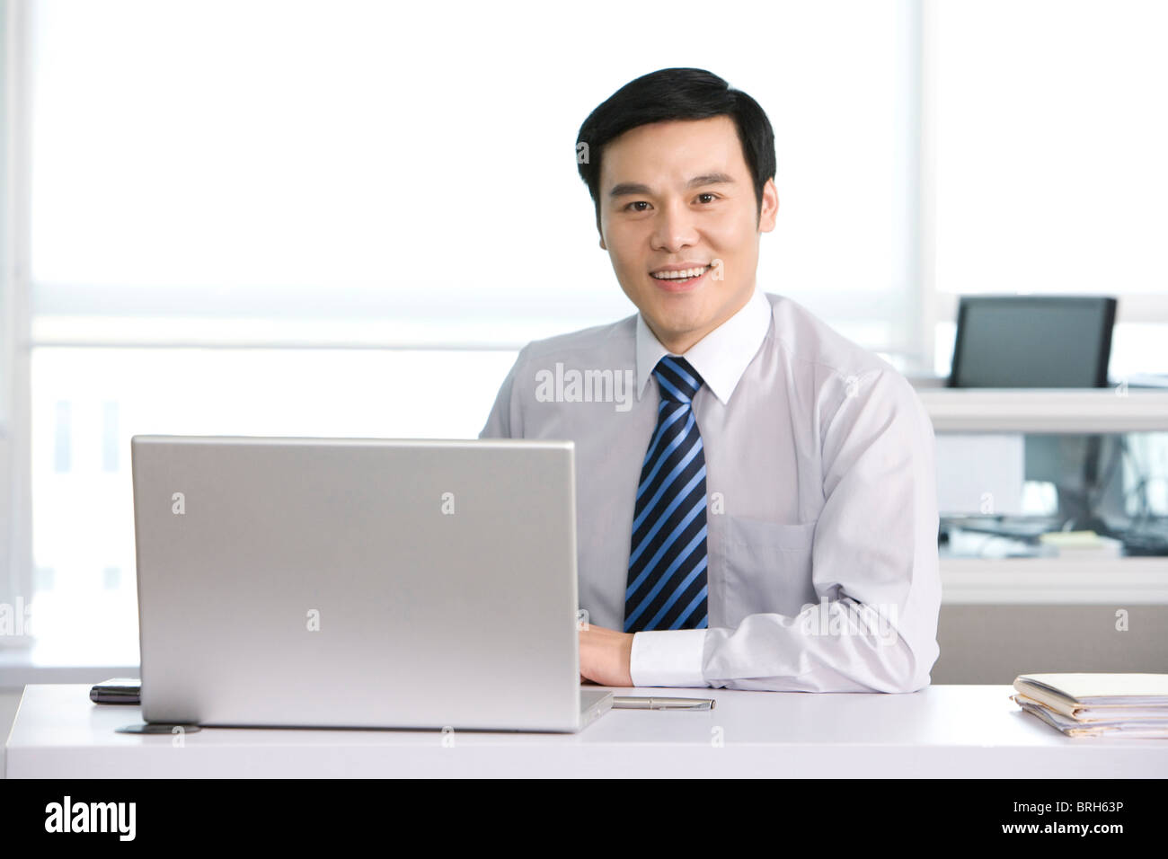 Office worker at his desk Stock Photo - Alamy