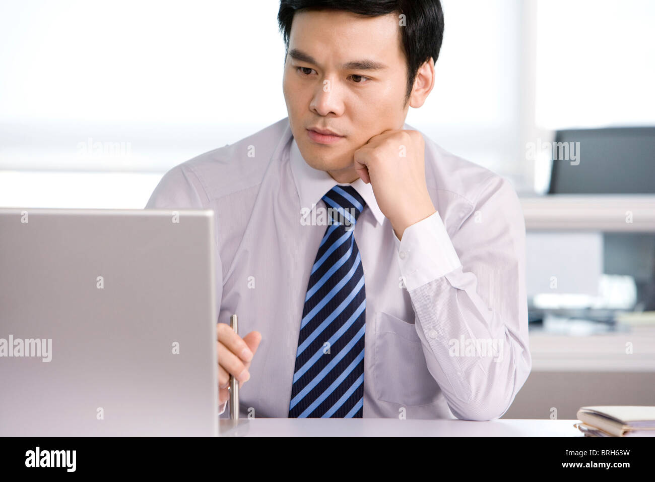 Office worker at his desk Stock Photo - Alamy