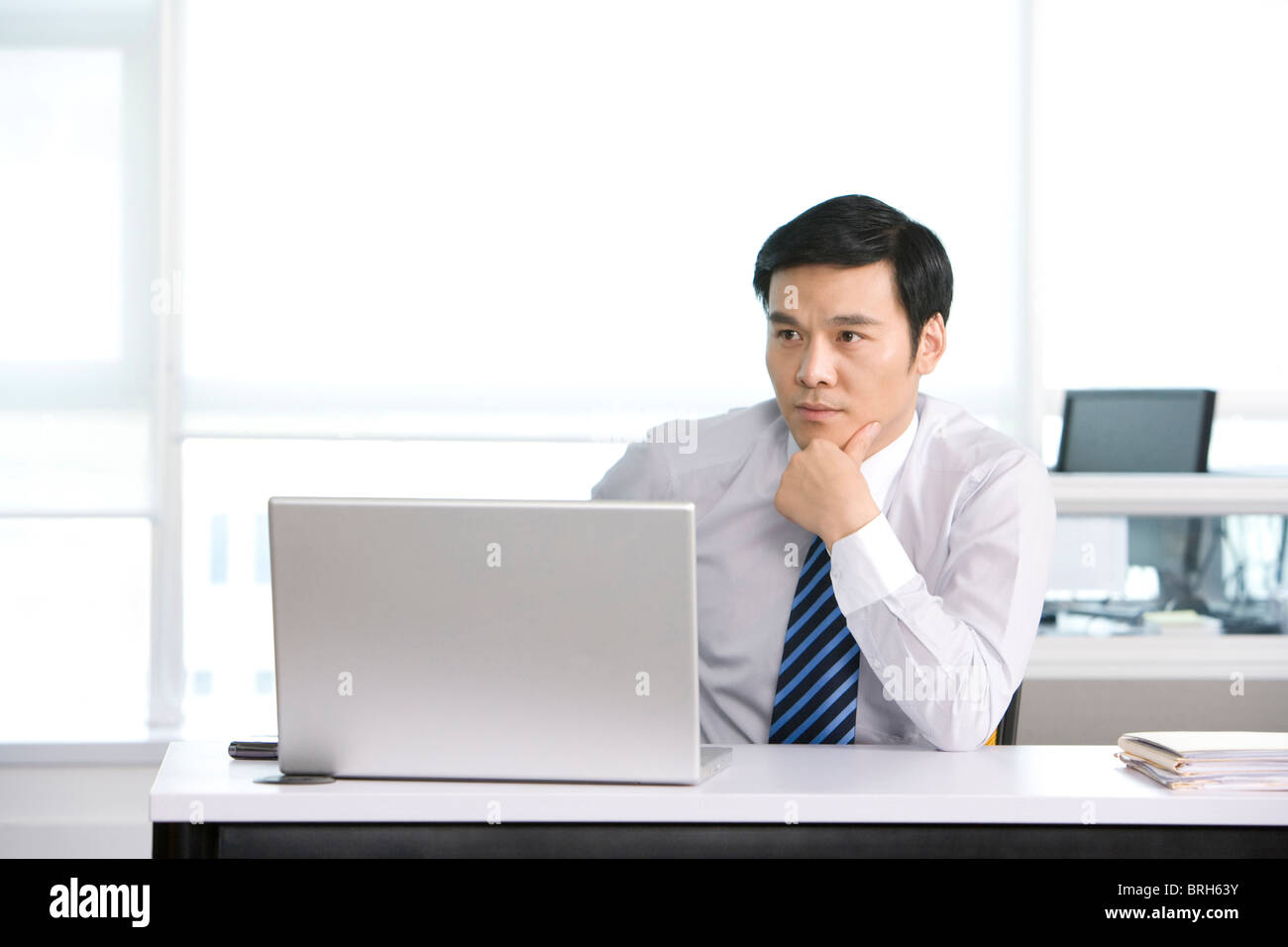 Office worker at his desk Stock Photo - Alamy