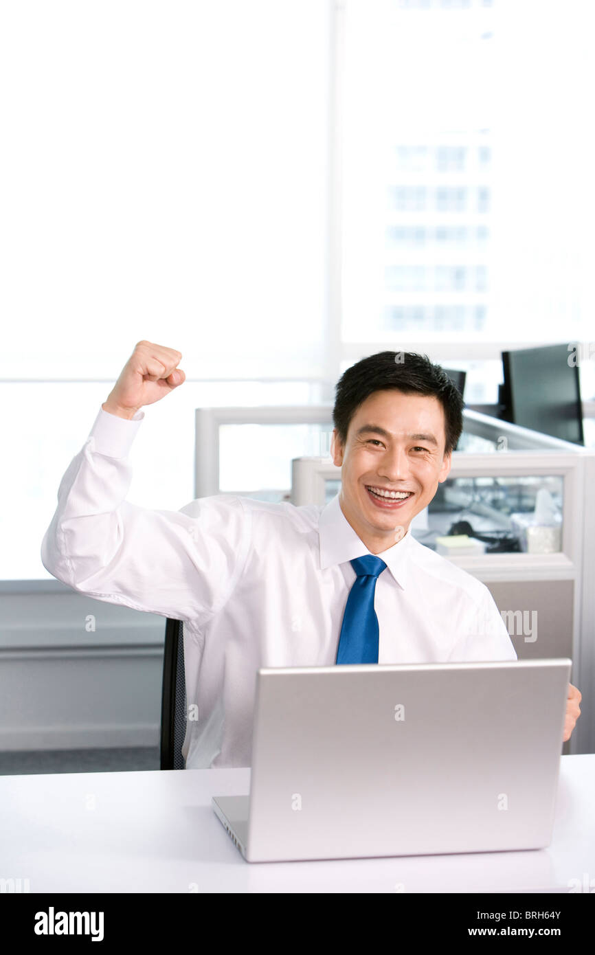 Happy office worker at his desk Stock Photo - Alamy