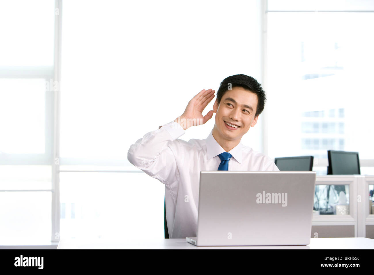 Happy office worker at his desk Stock Photo - Alamy