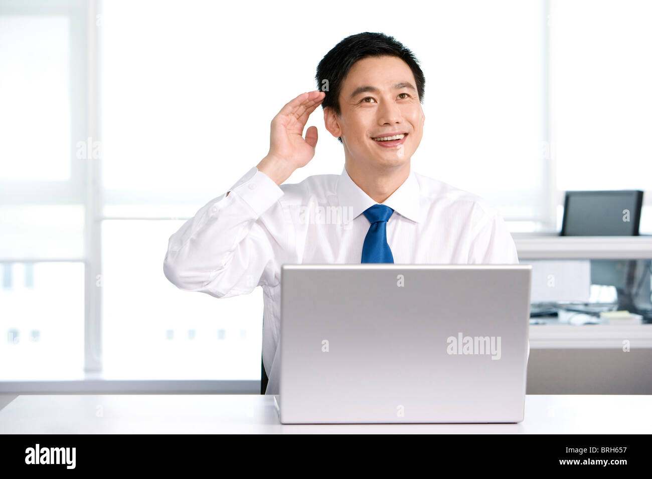 Happy office worker at his desk Stock Photo - Alamy