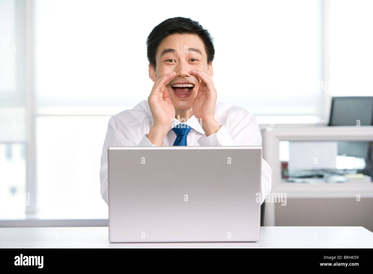 Happy office worker at his desk Stock Photo - Alamy