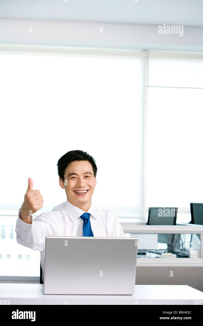 Happy office worker at his desk Stock Photo - Alamy