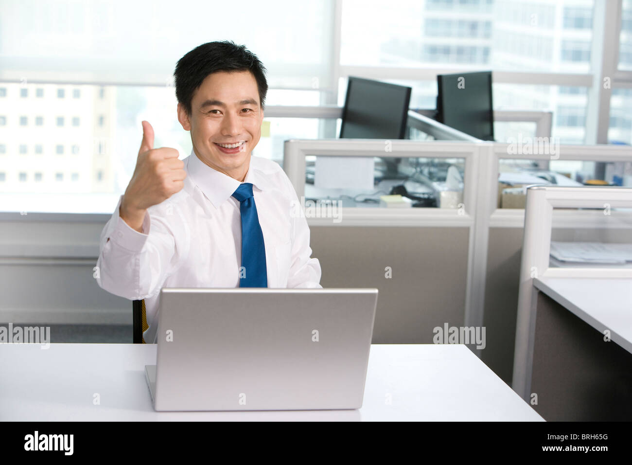 Happy office worker at his desk Stock Photo - Alamy