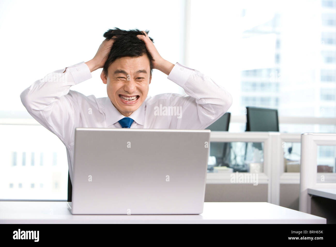 Frustrated office work at his desk Stock Photo - Alamy