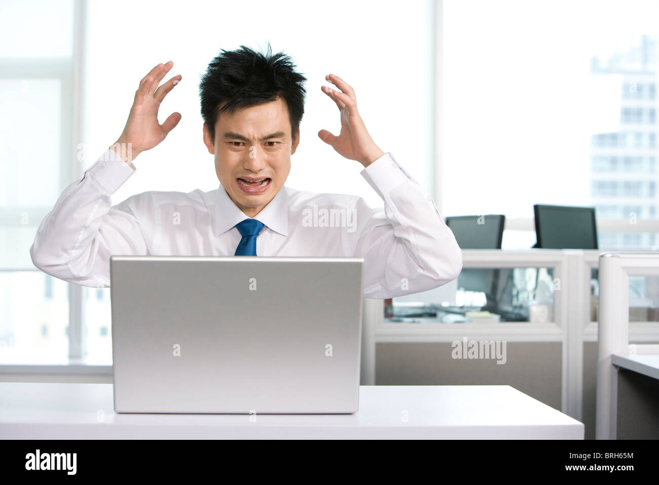Frustrated office work at his desk Stock Photo - Alamy