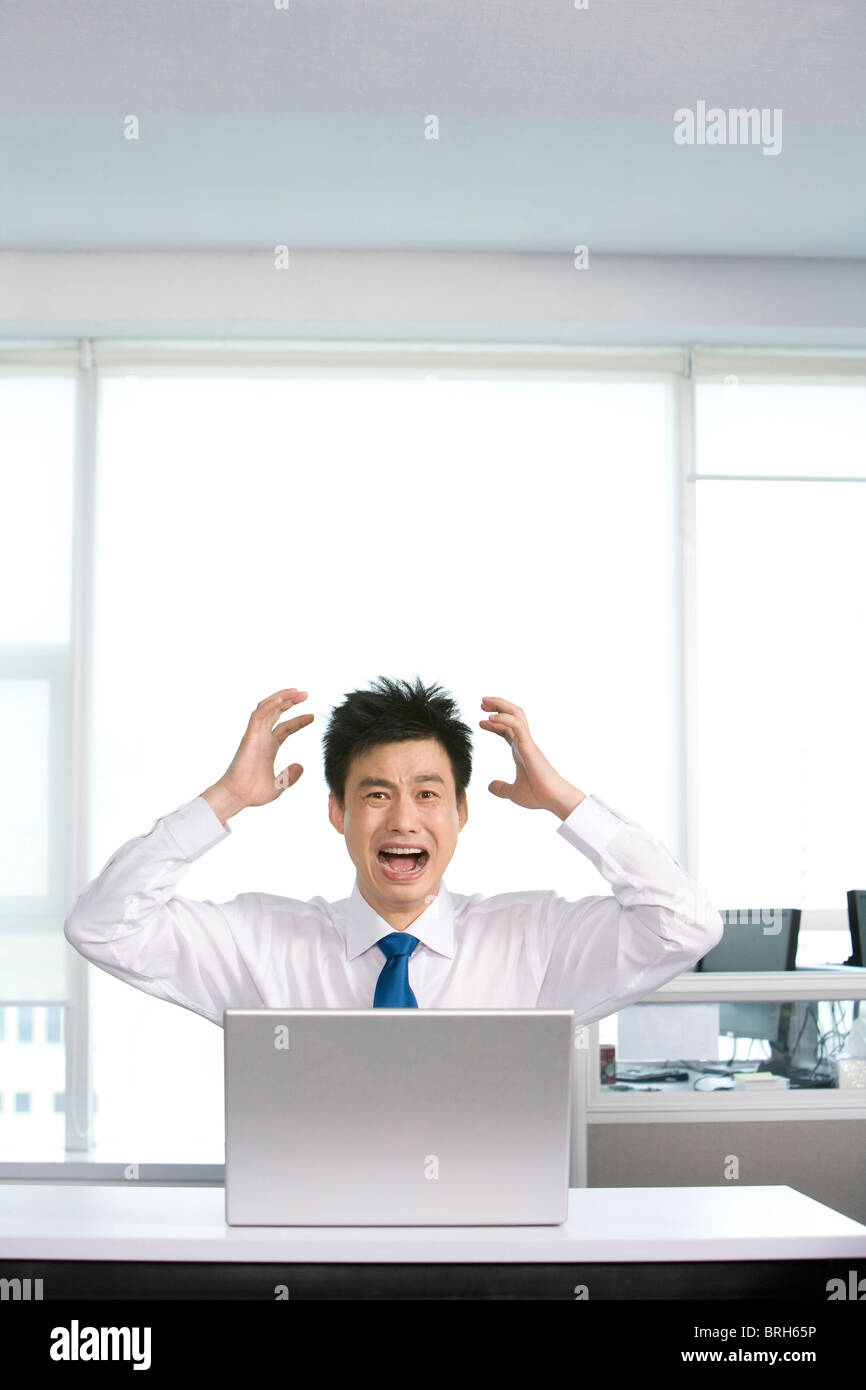 Frustrated office work at his desk Stock Photo - Alamy