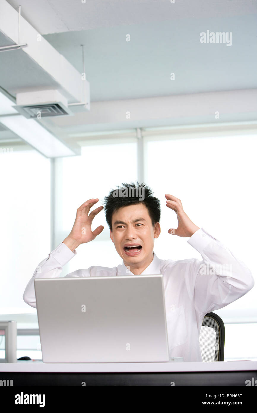 Frustrated office work at his desk Stock Photo - Alamy