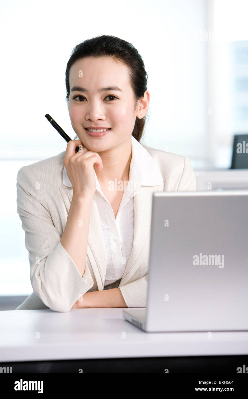 Office worker at her desk Stock Photo - Alamy