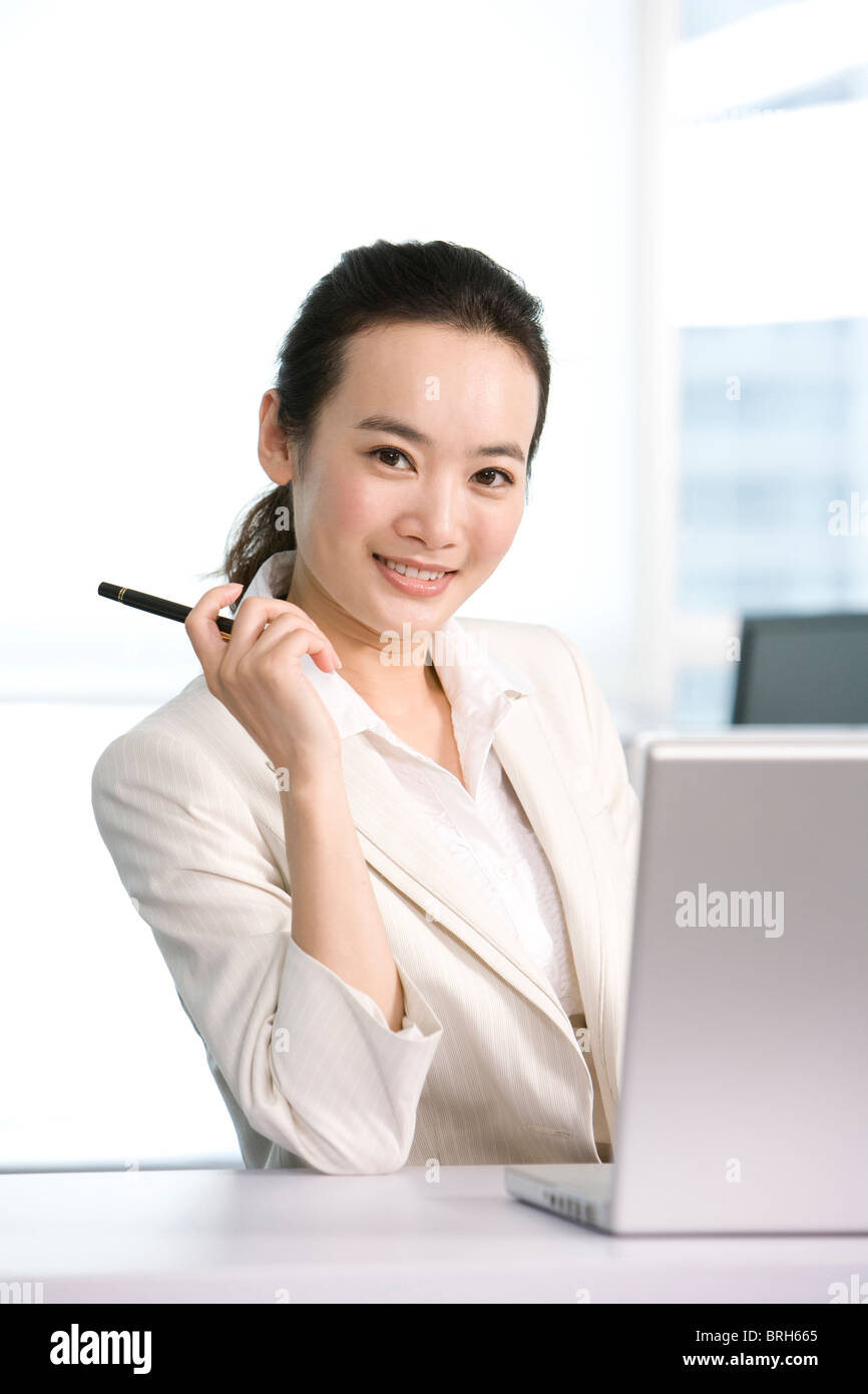 Office worker at her desk Stock Photo - Alamy