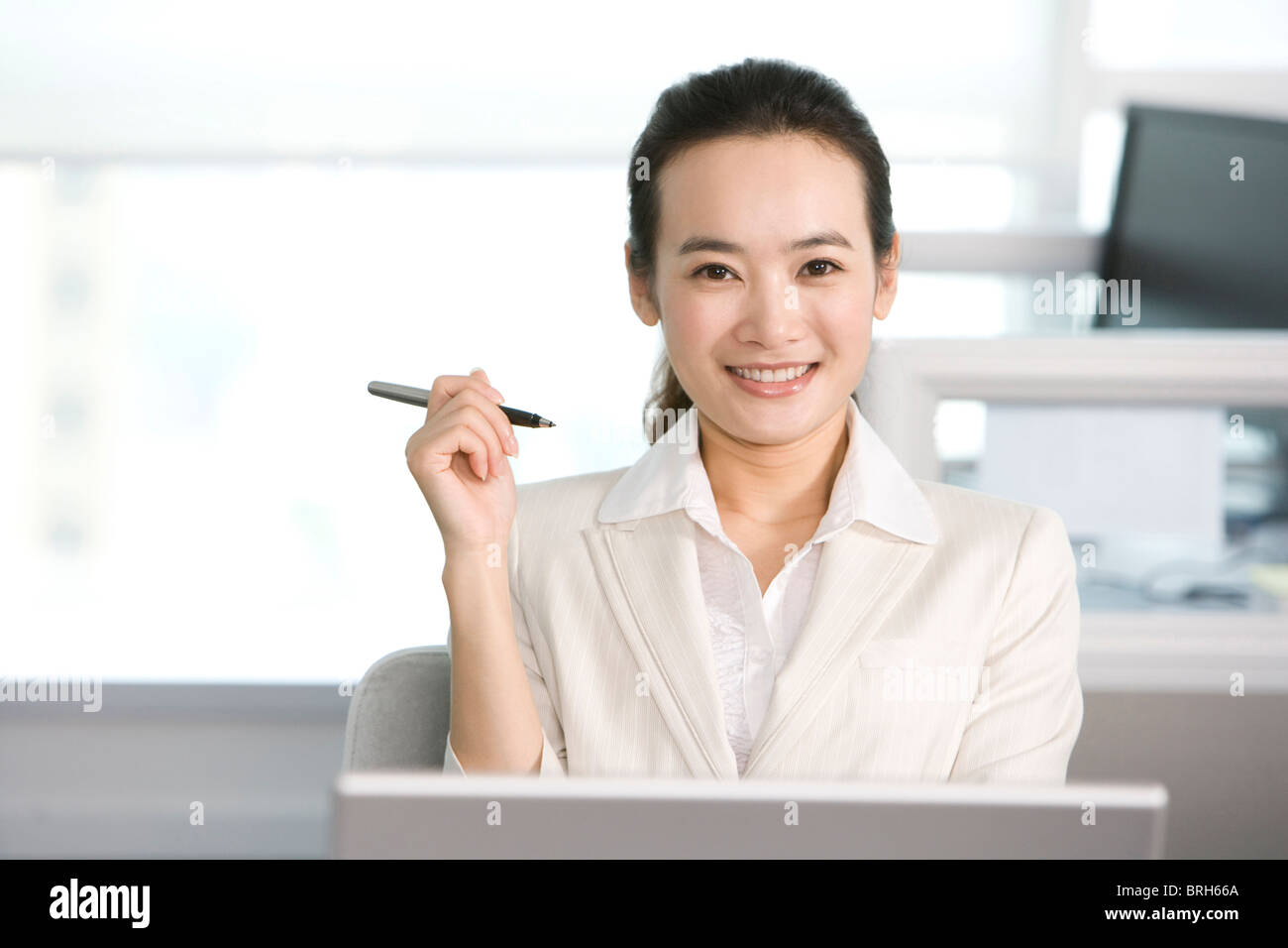 Office worker at her desk Stock Photo - Alamy