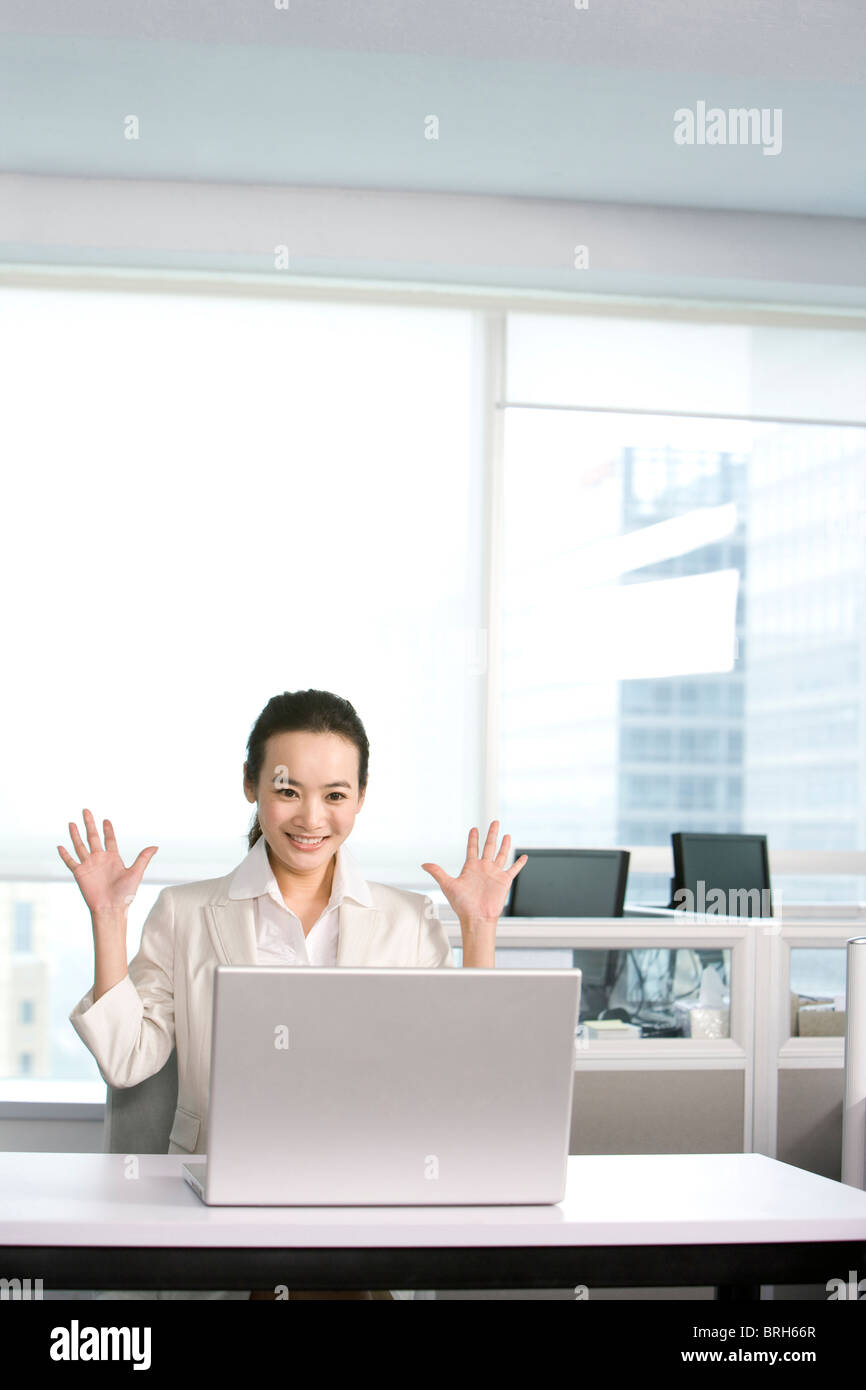 Happy office worker at her desk Stock Photo - Alamy