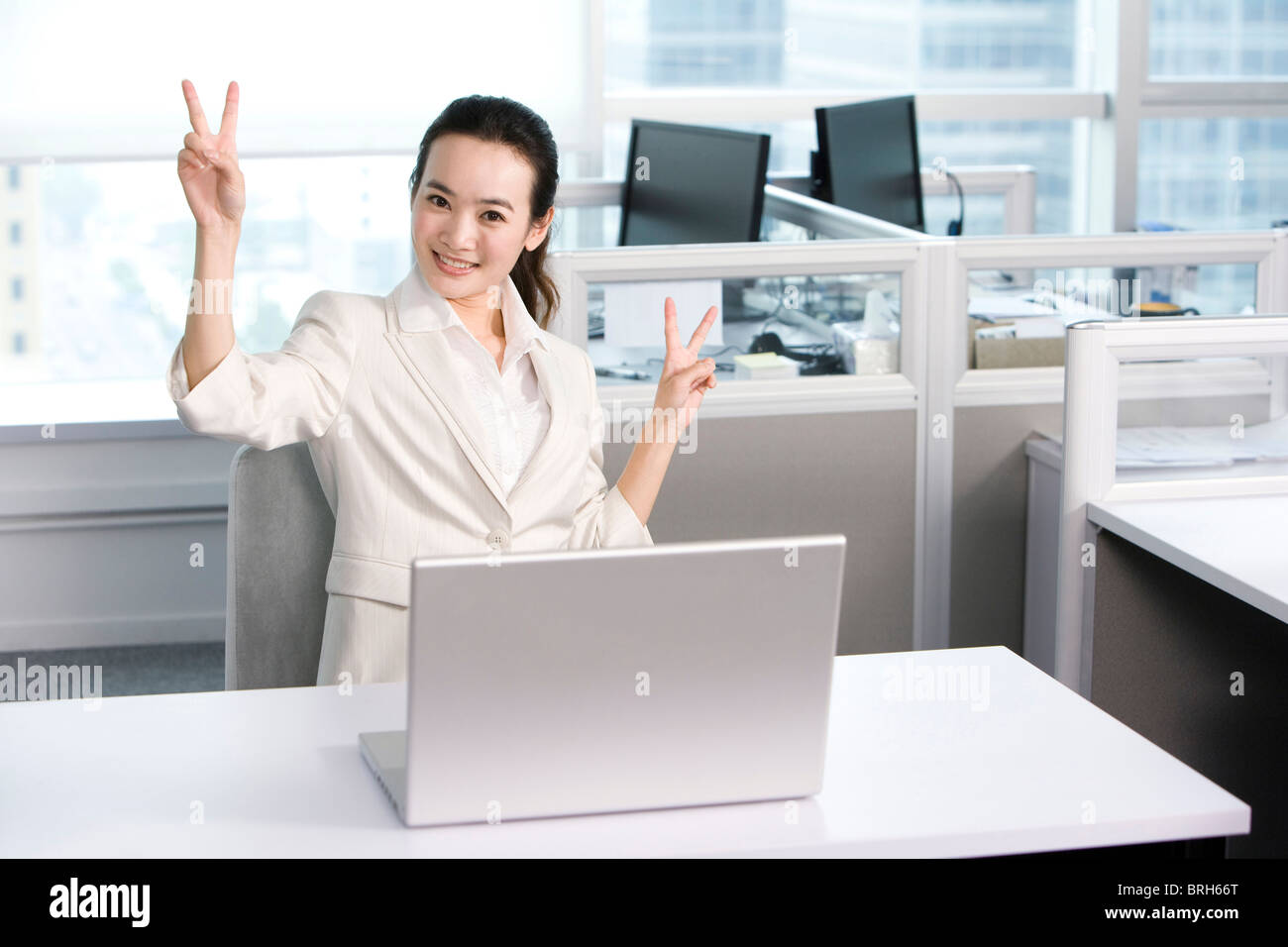 Happy office worker at her desk Stock Photo - Alamy