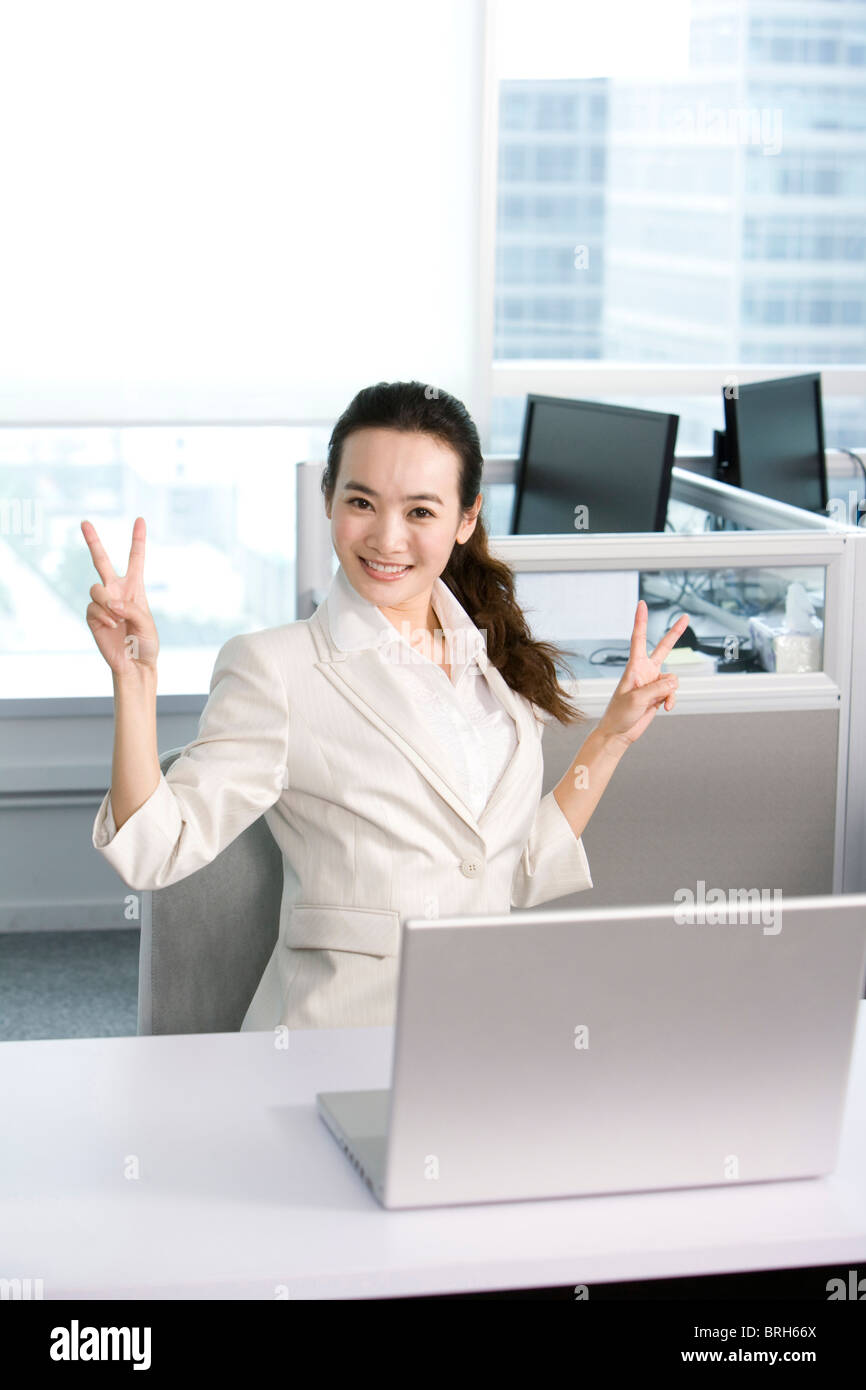 Happy office worker at her desk Stock Photo - Alamy