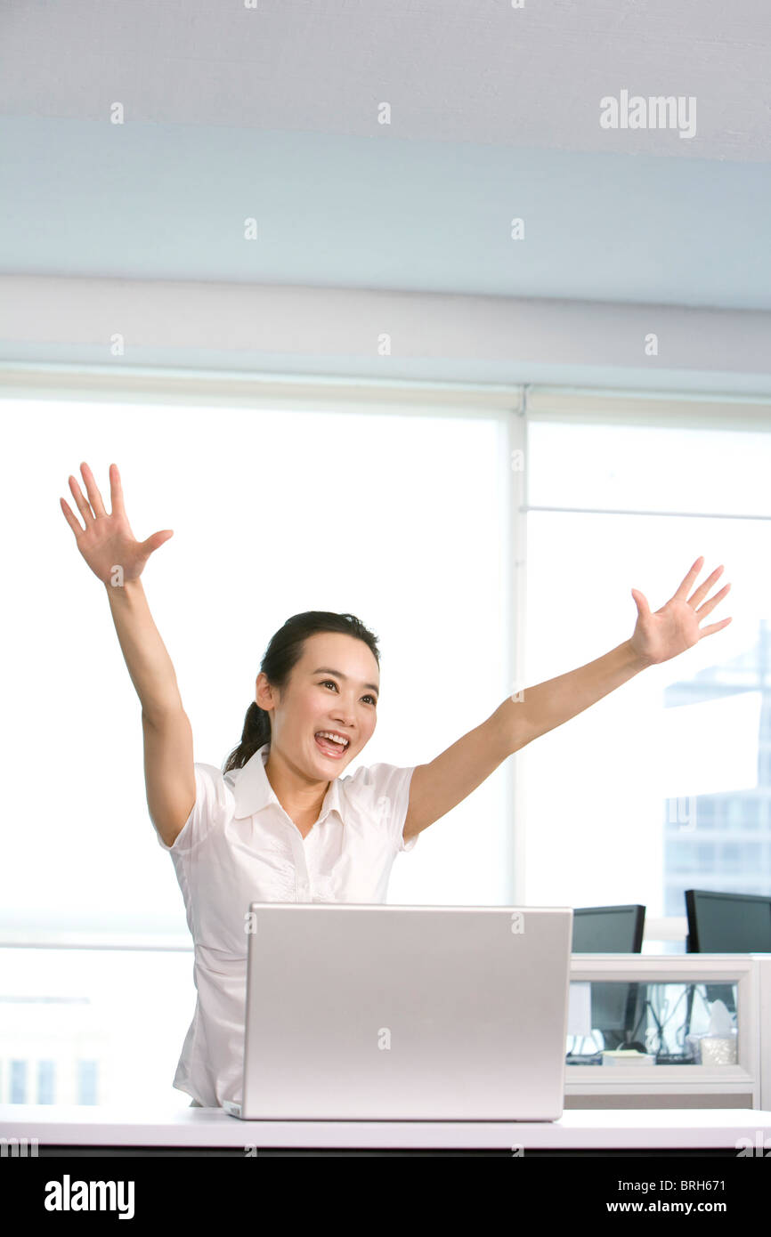 Happy office worker at her desk Stock Photo - Alamy