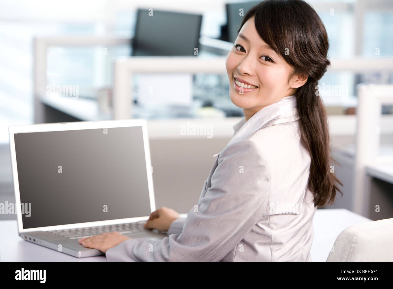 Office worker at her desk Stock Photo - Alamy