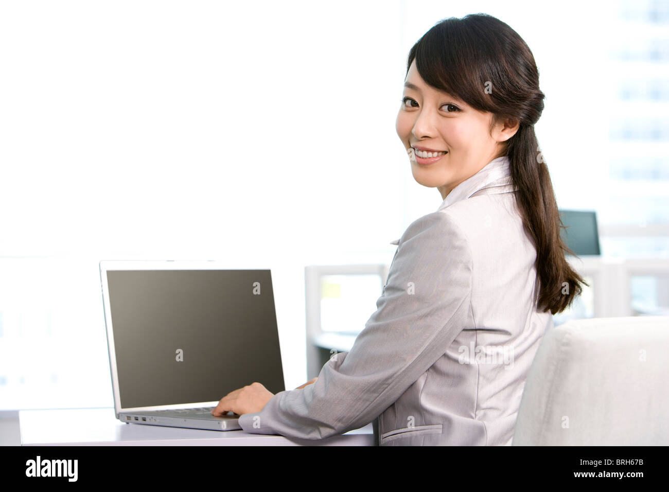 Office worker at her desk Stock Photo - Alamy
