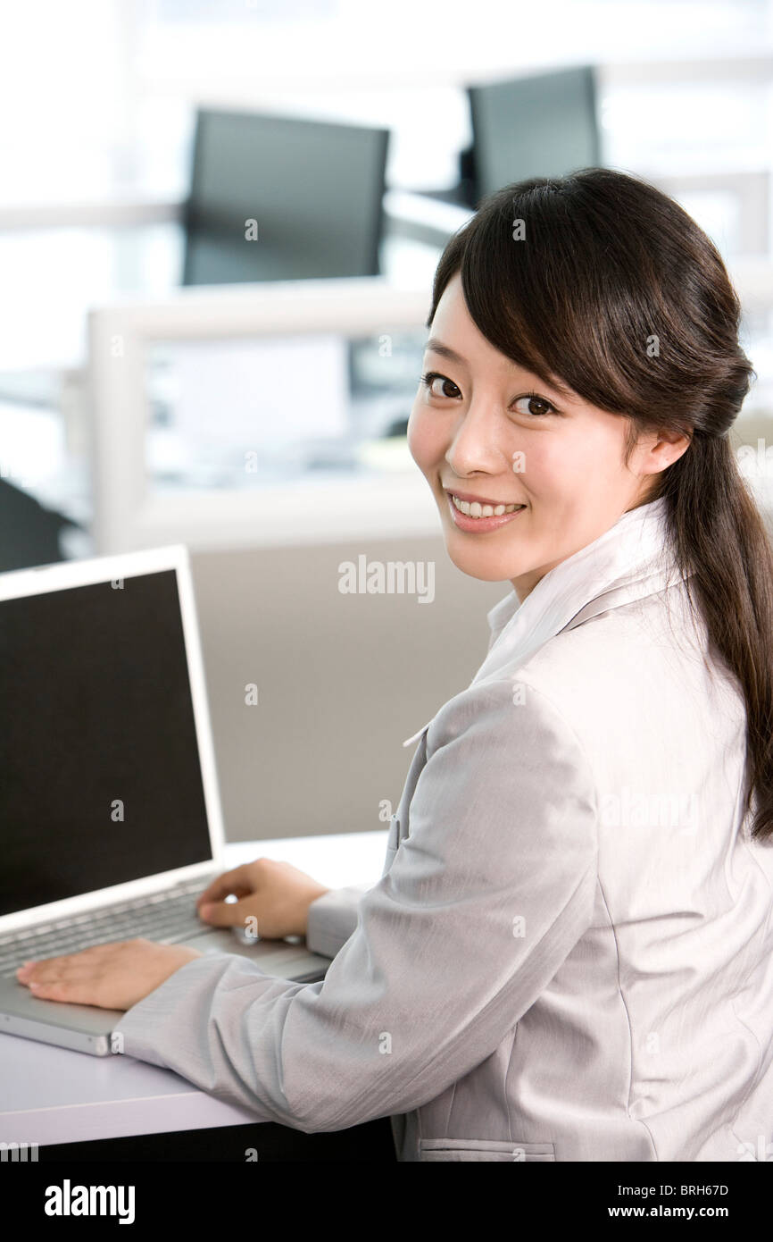 Office worker at her desk Stock Photo - Alamy