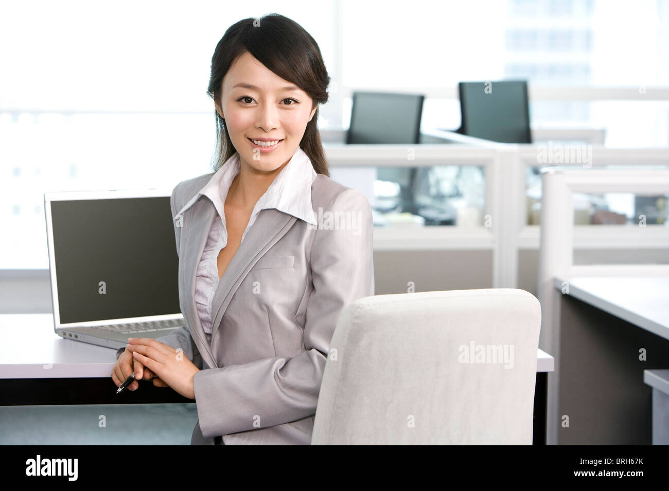 Office worker at her desk Stock Photo - Alamy