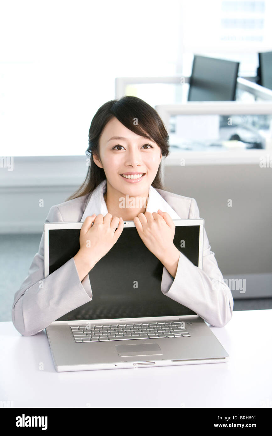 Office worker hugging her computer Stock Photo - Alamy