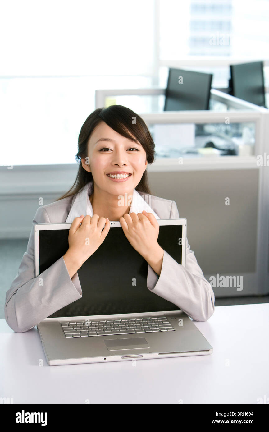 Office worker hugging her computer Stock Photo - Alamy