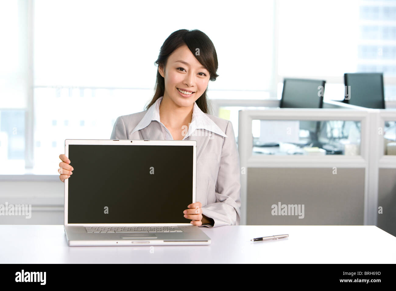 Office worker at her desk Stock Photo - Alamy