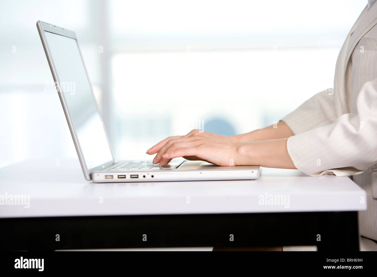 Office worker using her computer Stock Photo - Alamy