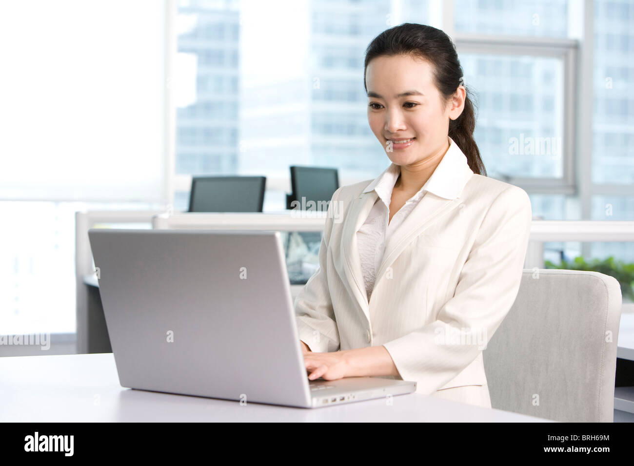 Office worker using her computer Stock Photo - Alamy