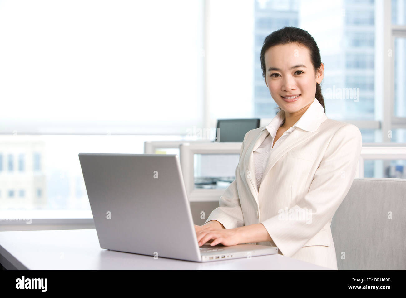 Office worker using her computer Stock Photo - Alamy