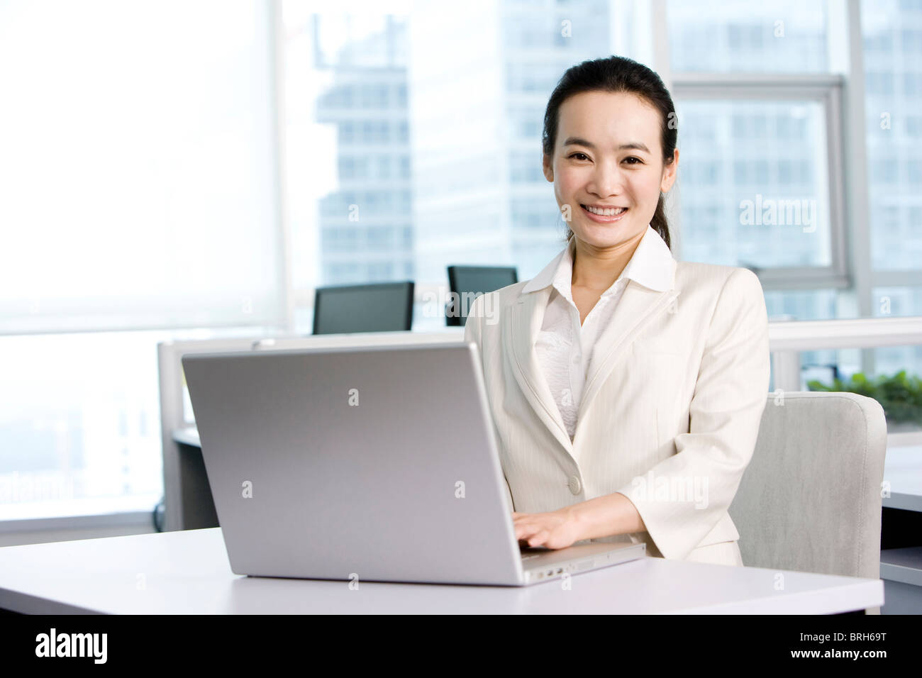 Office worker at her desk Stock Photo - Alamy