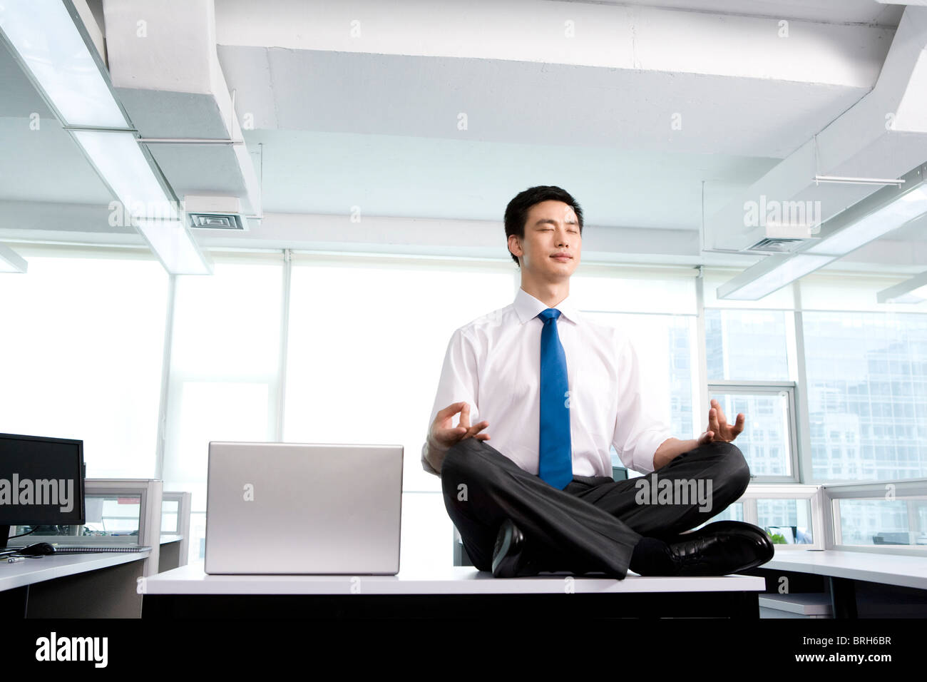 Meditation in the office Stock Photo - Alamy