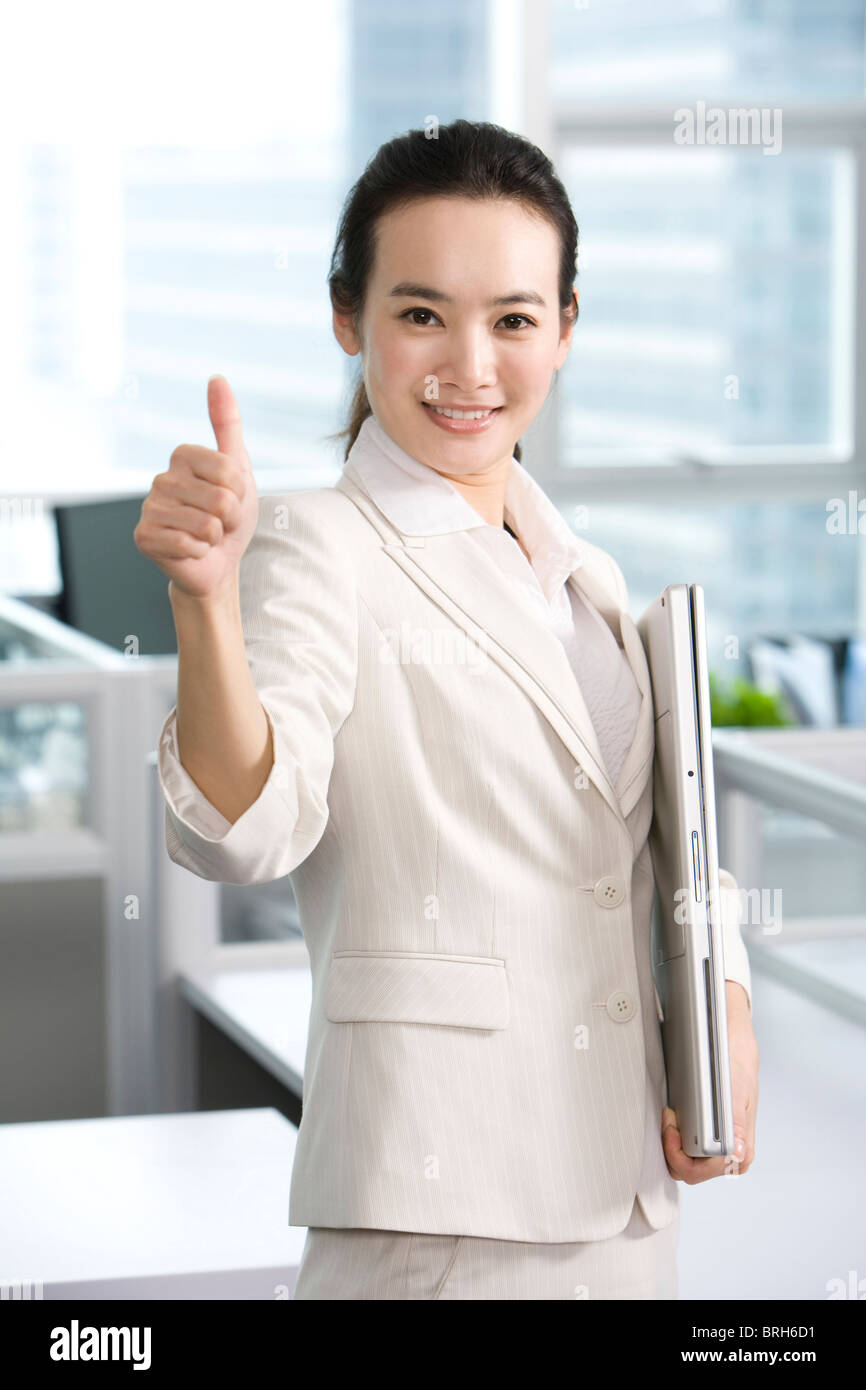 Office worker giving thumbs up Stock Photo - Alamy