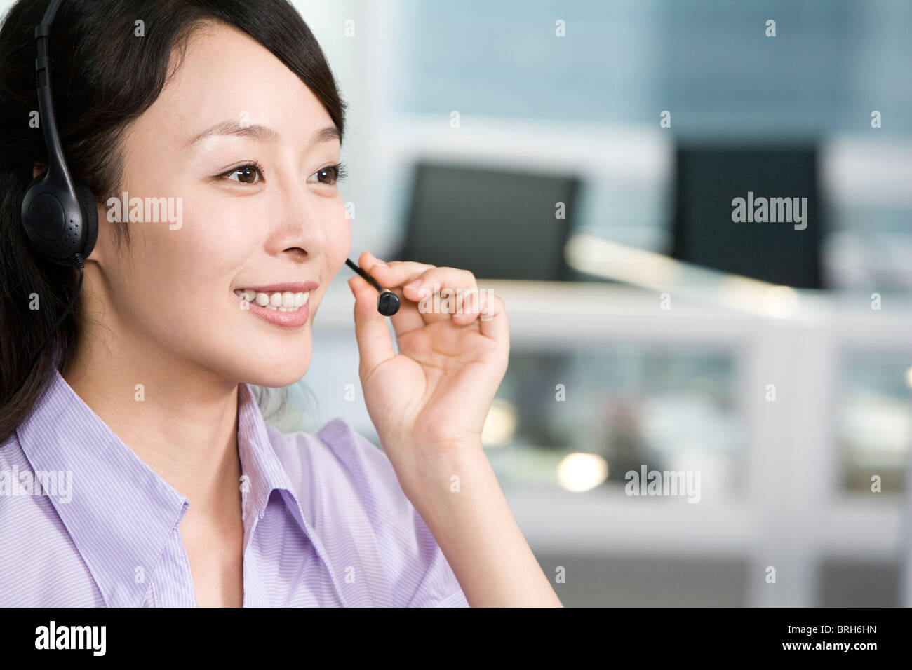 Office worker with a headset Stock Photo - Alamy