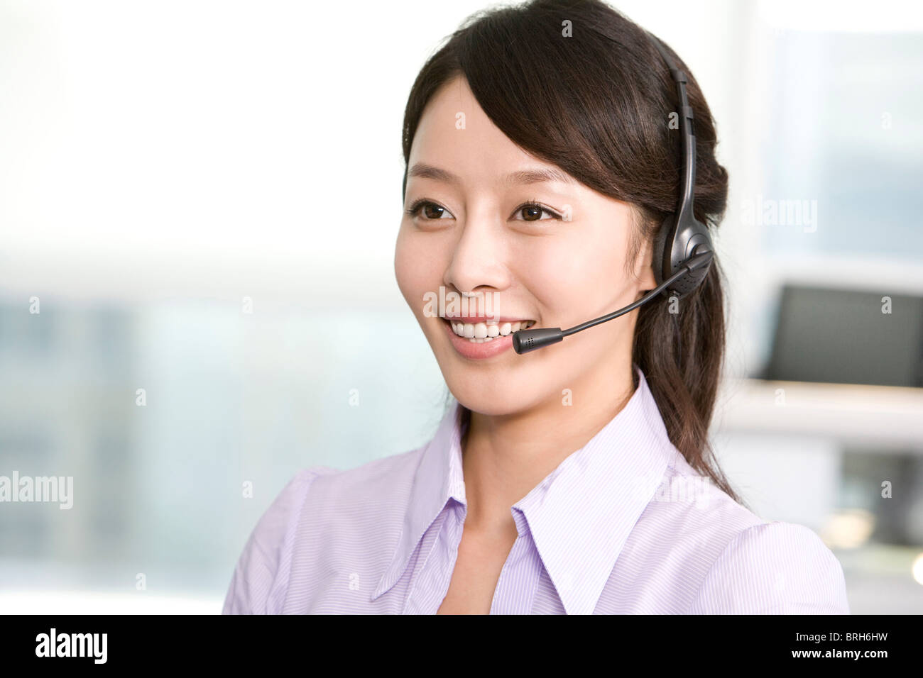 Office worker with a headset Stock Photo - Alamy
