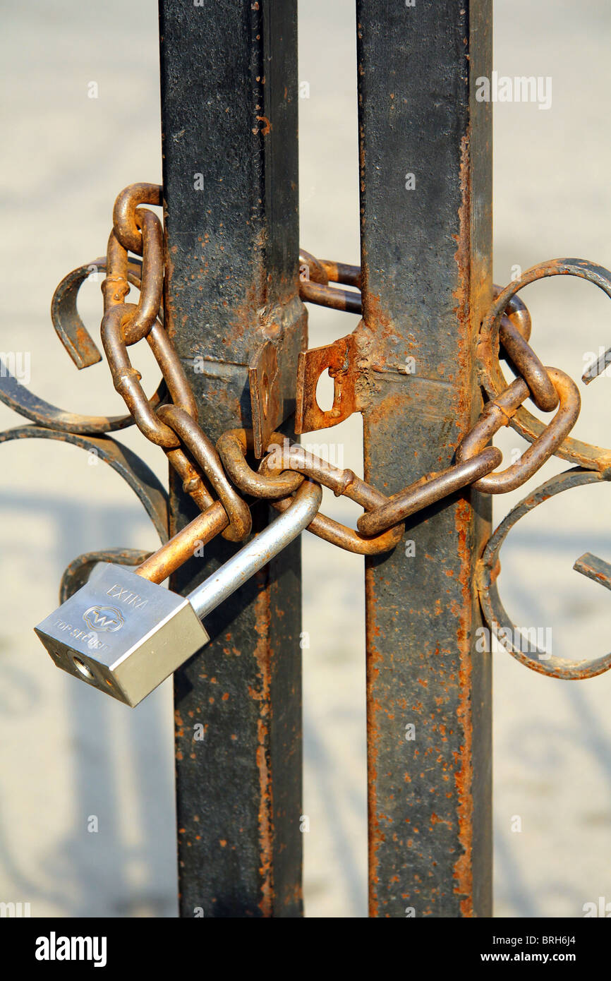 Castle with a big chain on an iron fence Stock Photo - Alamy