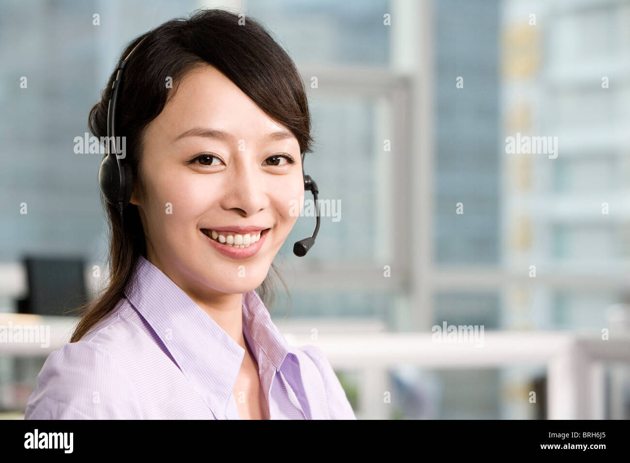 Office worker with a headset Stock Photo - Alamy