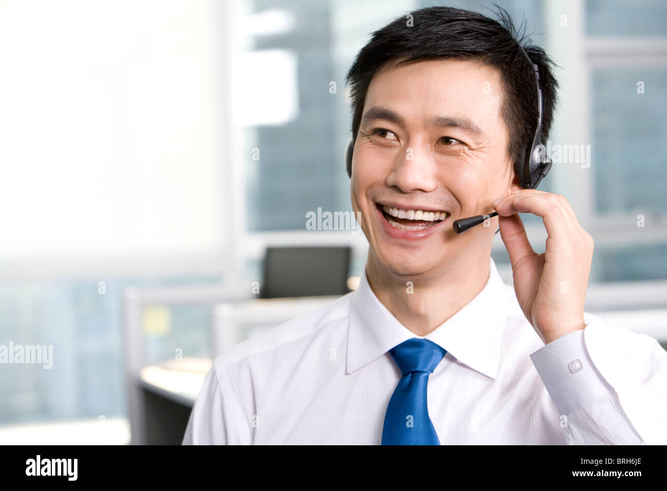 Office worker with a headset Stock Photo - Alamy