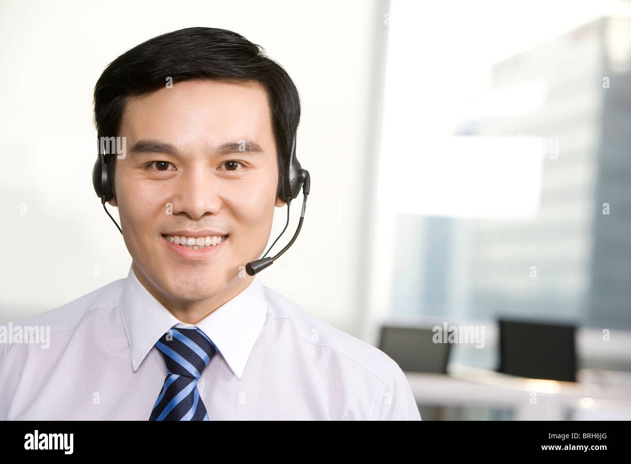 Office worker with a headset Stock Photo - Alamy