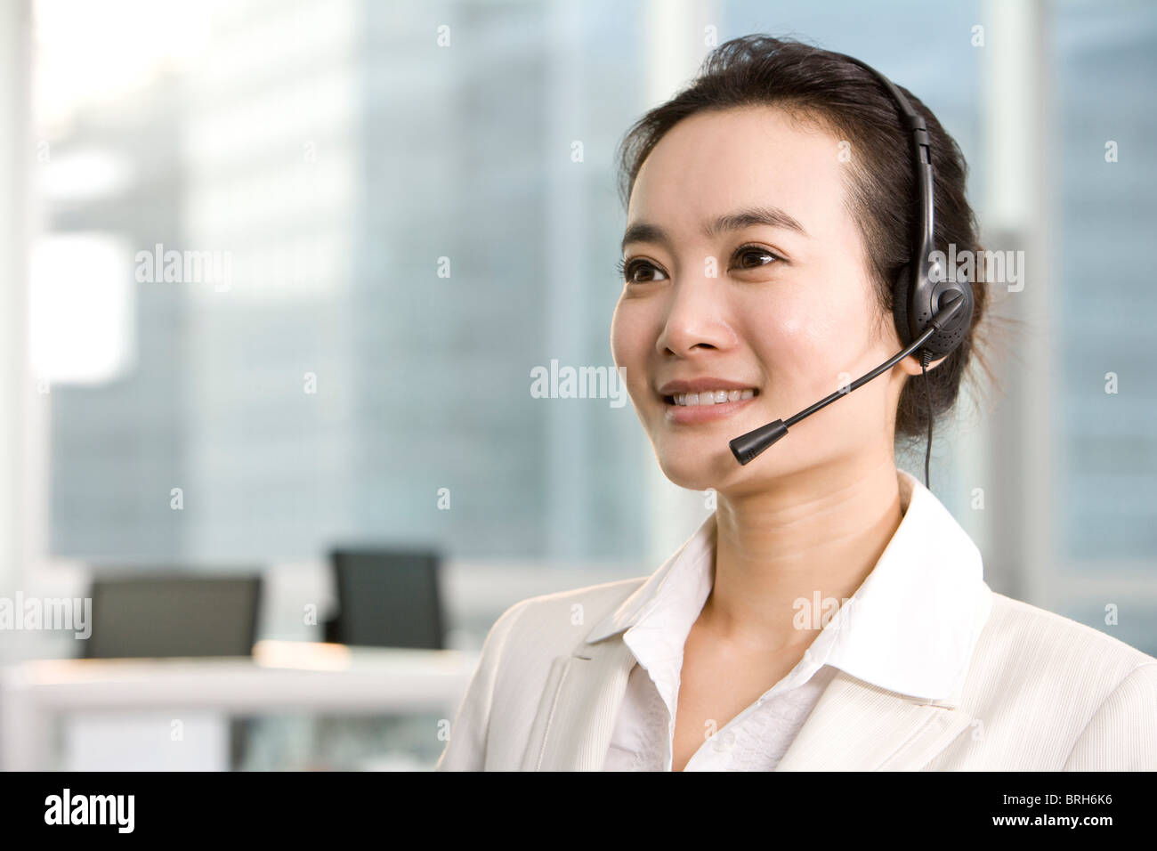 Office worker with a headset Stock Photo - Alamy