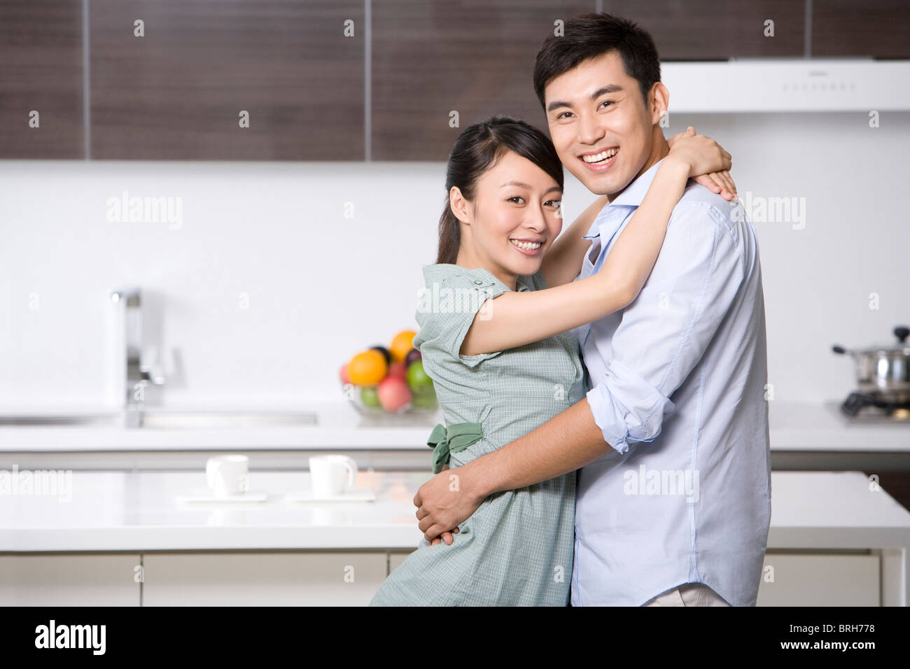 Portrait of a couple in the kitchen Stock Photo - Alamy