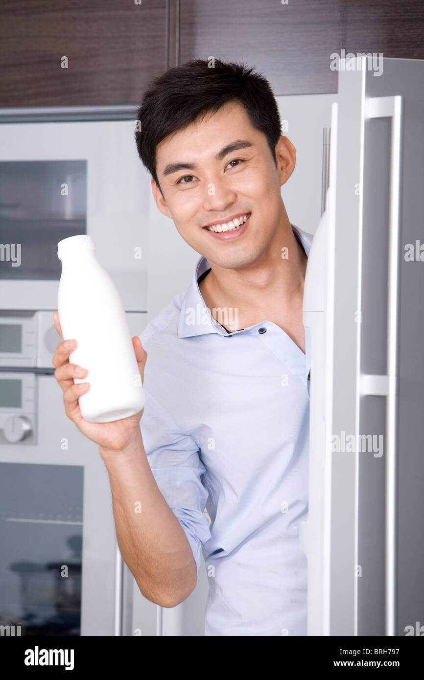 Man taking milk out of the fridge Stock Photo - Alamy