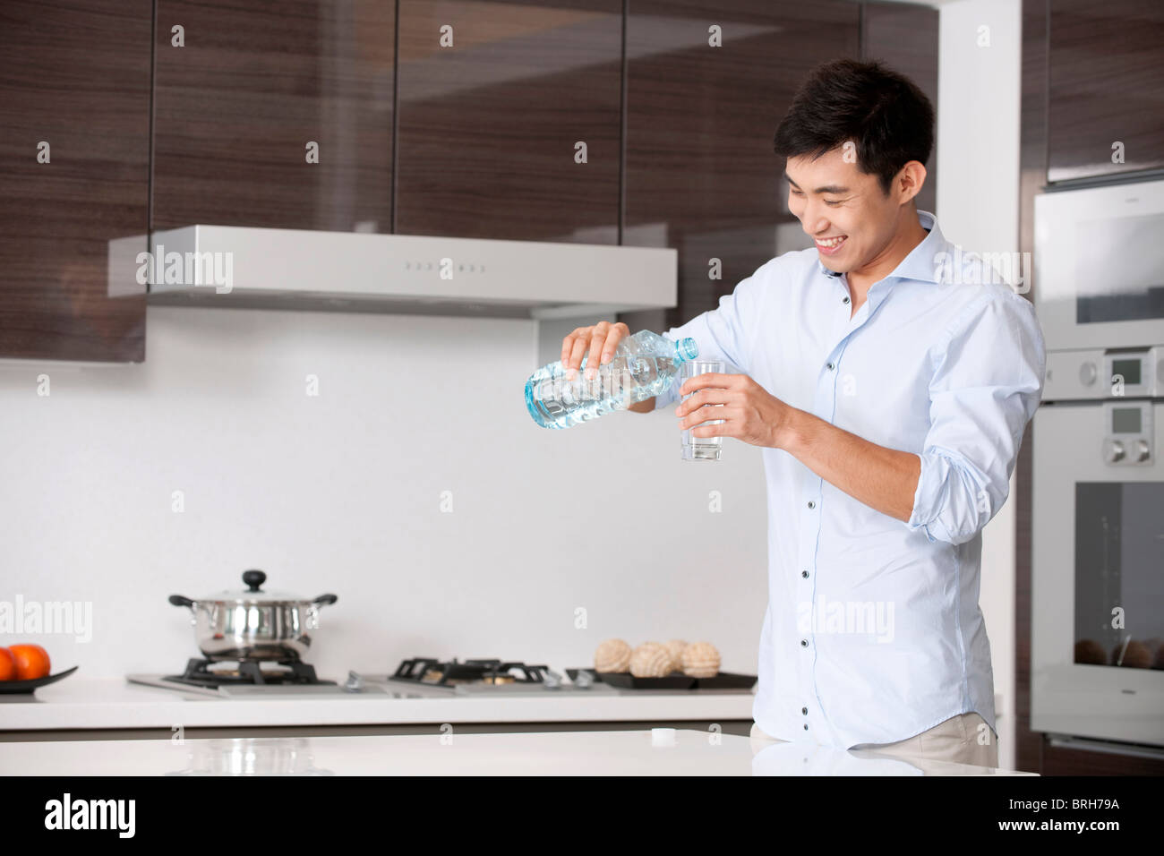 Man pouring a glass of water Stock Photo - Alamy