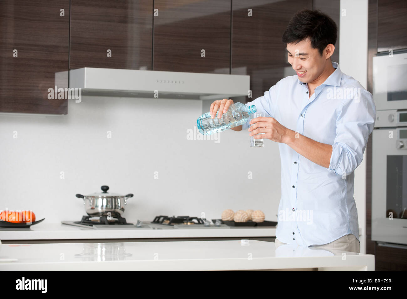 Man pouring a glass of water Stock Photo - Alamy