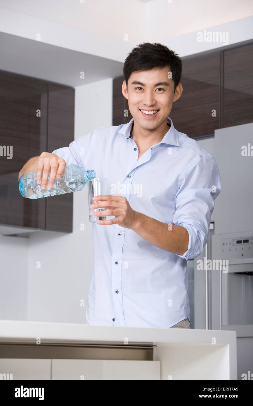 Man pouring a glass of water Stock Photo - Alamy