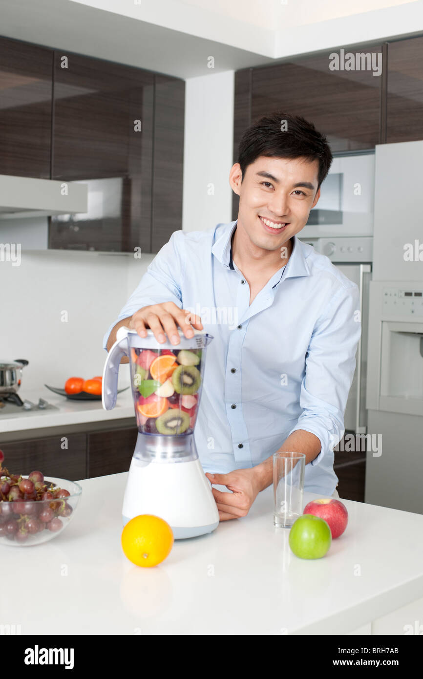 Man making fresh fruit juice Stock Photo - Alamy