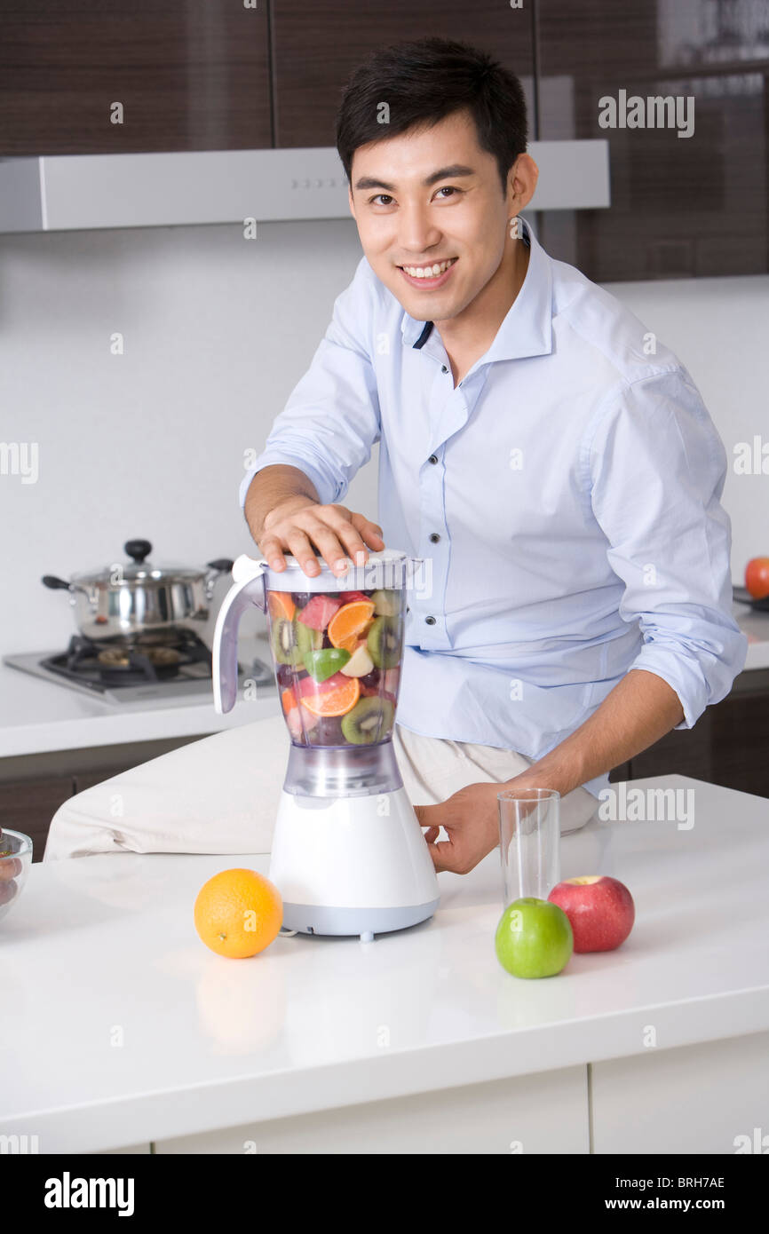 Man making fresh fruit juice Stock Photo - Alamy