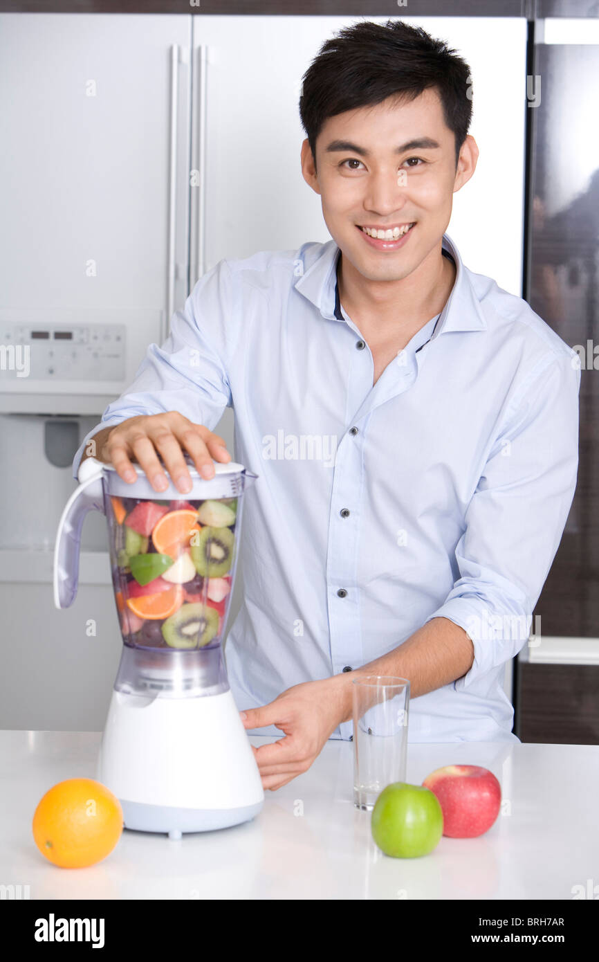 Man making fresh fruit juice Stock Photo - Alamy