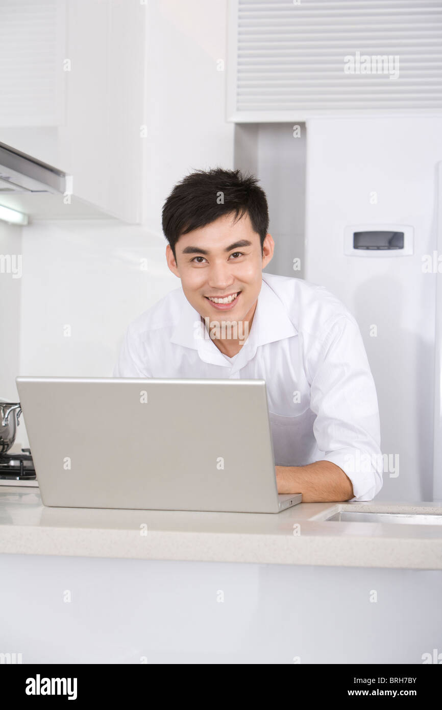 Man using laptop computer at home Stock Photo - Alamy