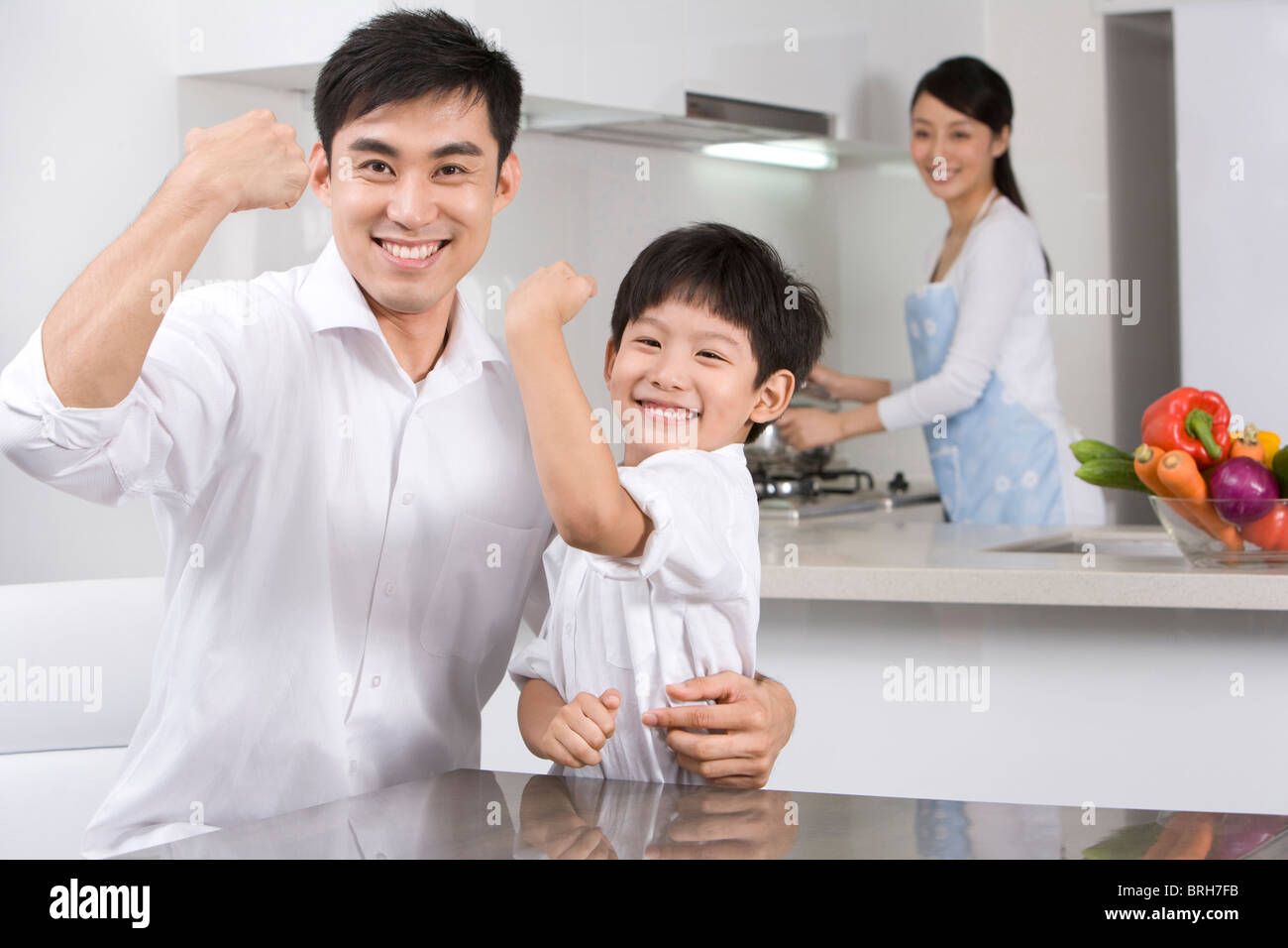 Family in modern kitchen Stock Photo - Alamy